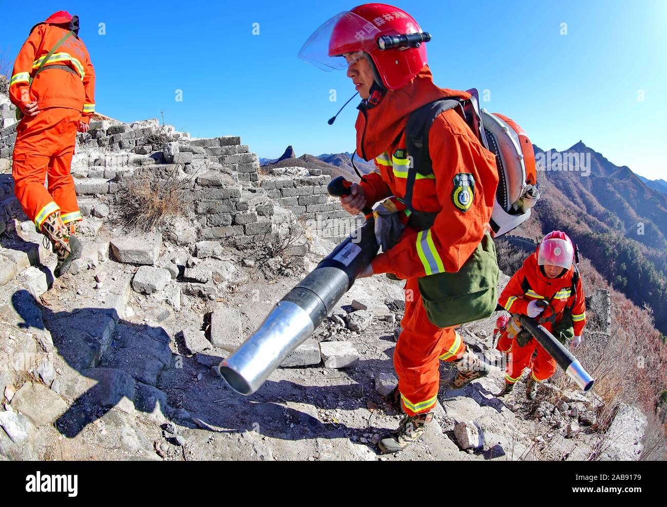 Chinese firefighters from the local forest firefighting brigade patrol ...