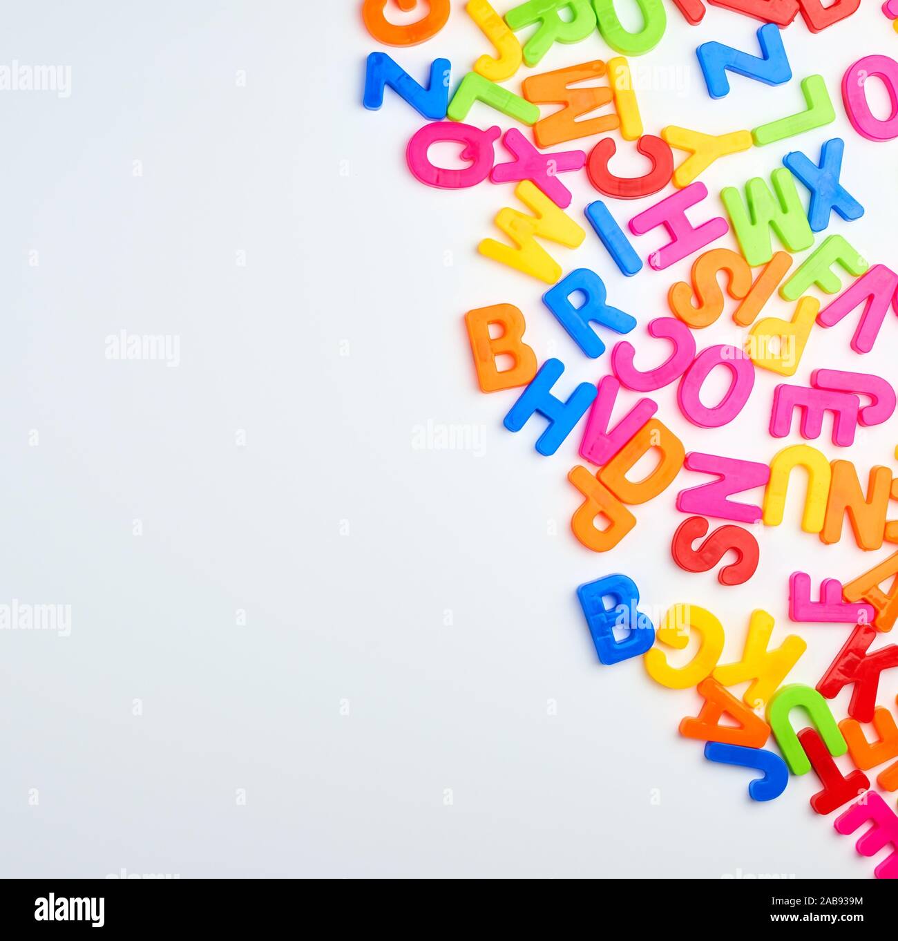 multicolored English alphabet letters on a white background, copy space ...