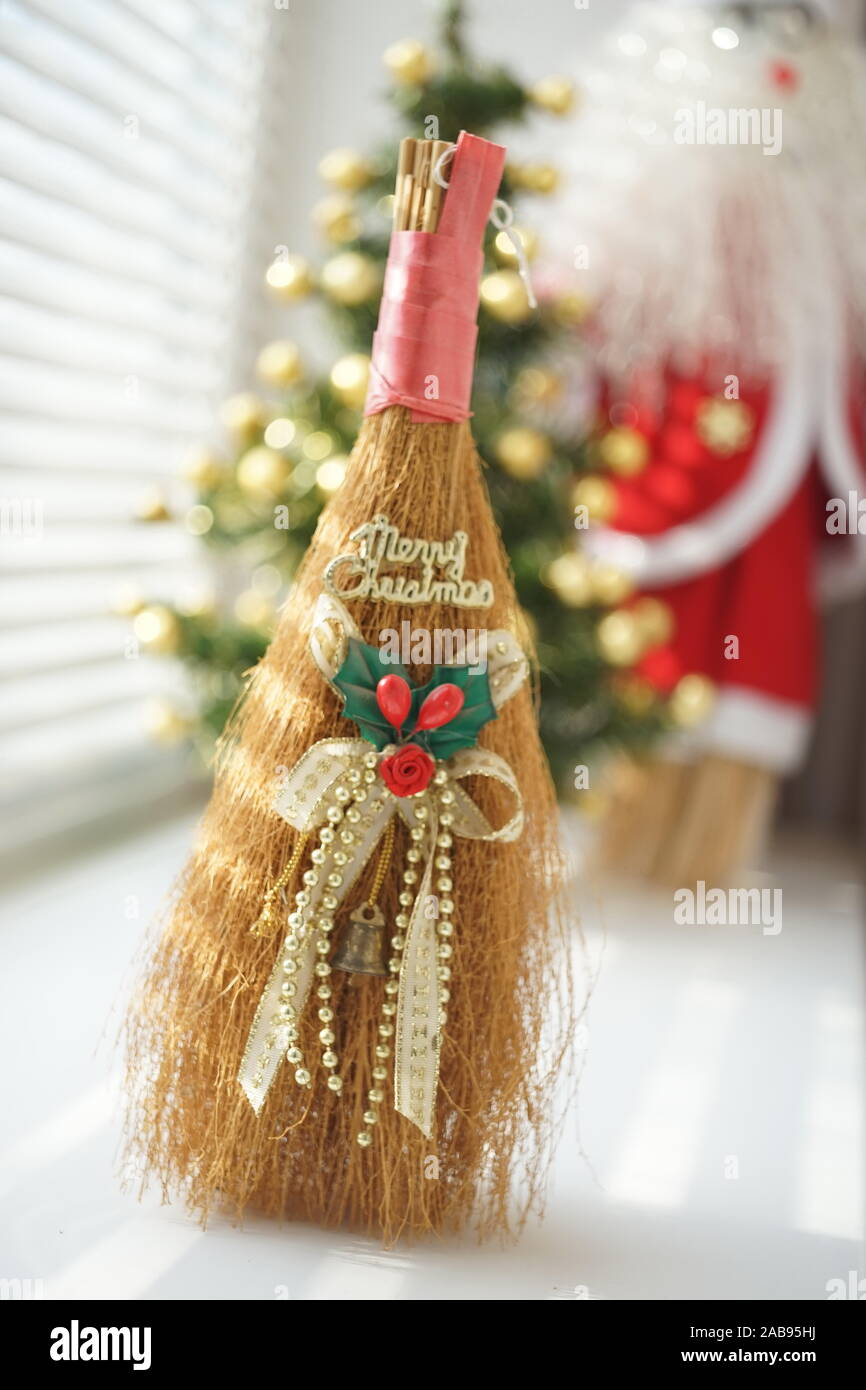 Broom toy with decor and golden text Merry Christmas on white ...