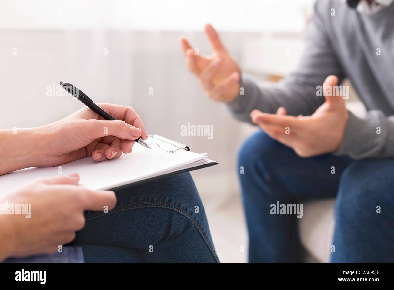 Psychotherapist writing notes, giving diagnosis to emotional man Stock ...