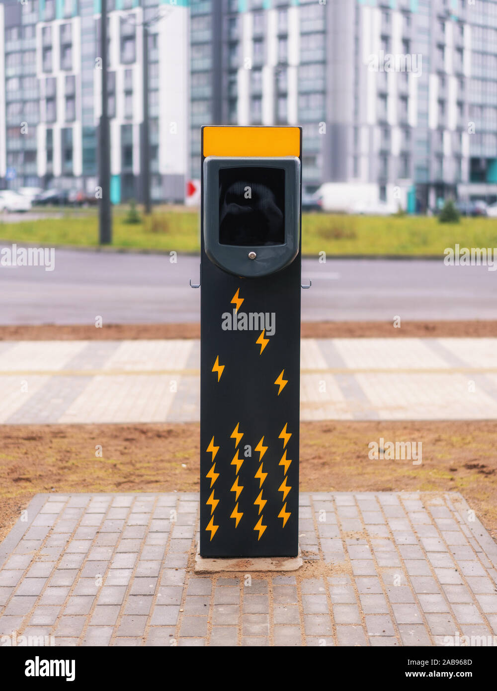 Modern electric car charging at station dock point near parking lot on ...