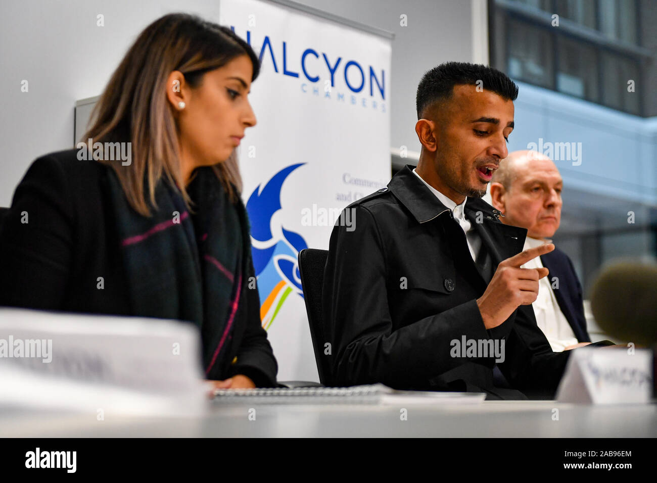 Defendant Shakeel Afsar (right) speaks to media after a High Court ...