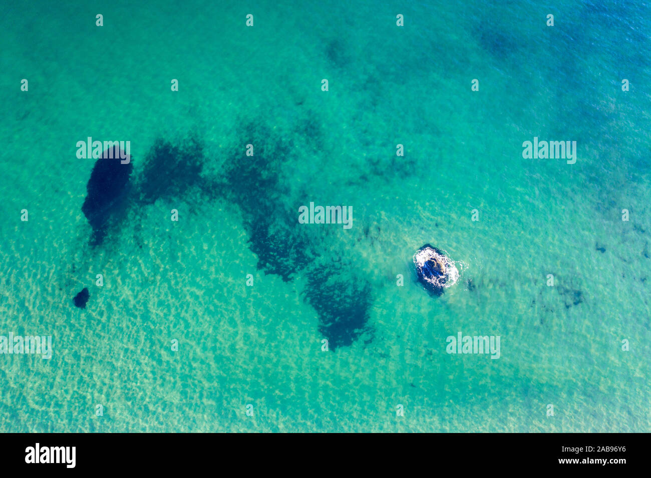 Top down aerial view over clear blue sea shallows at Durness Beach in ...