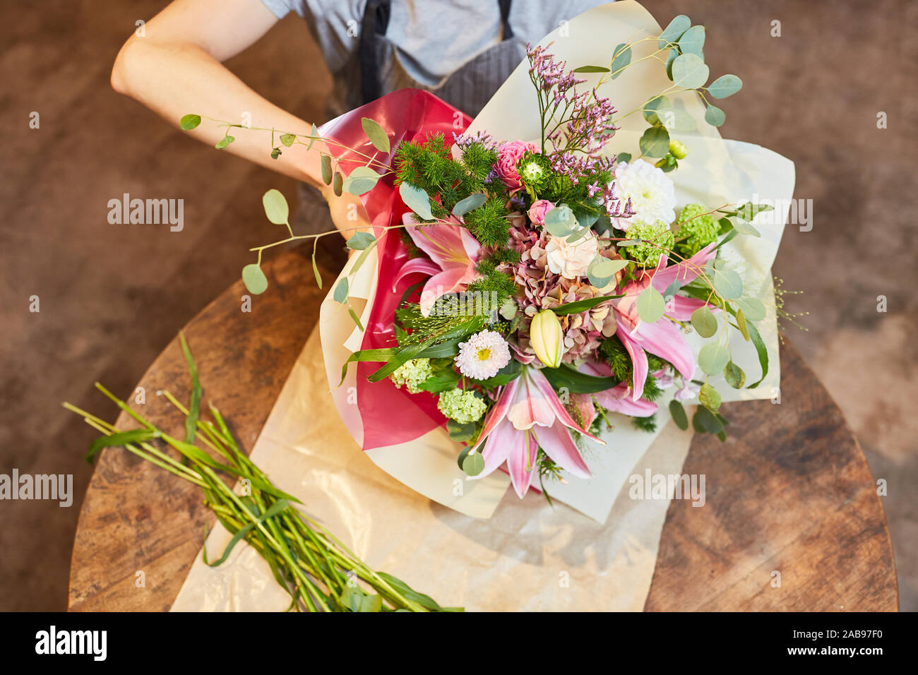 A colorful bouquet is wrapped in paper for flower delivery Stock Photo ...
