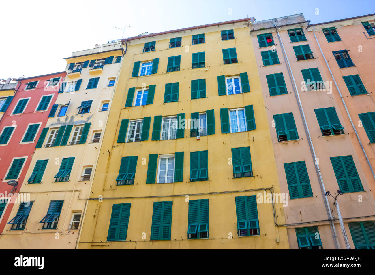 Facades of old Italian buildings in old part of town, windows with ...