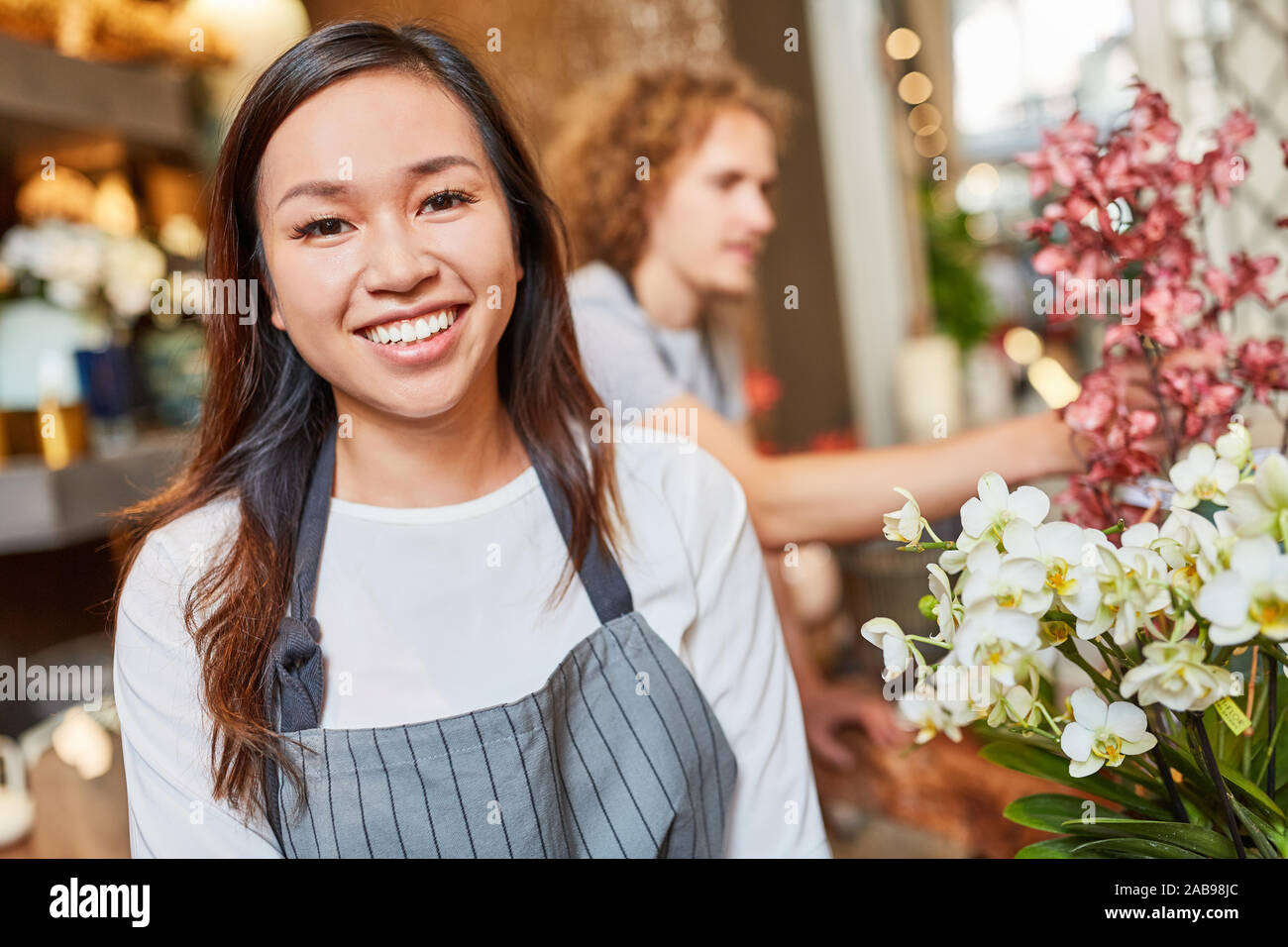 Smiling positive female florist hi-res stock photography and images - Alamy