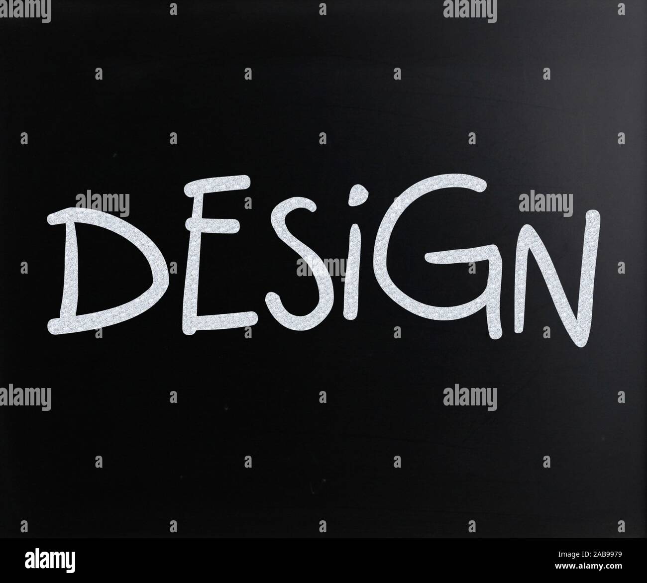 The word ""Design"" handwritten with white chalk on a blackboard Stock ...