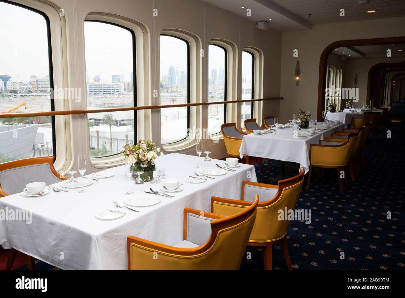 Tables set for afternoon tea onboard Queen Elizabeth 2 docked in Dubai ...