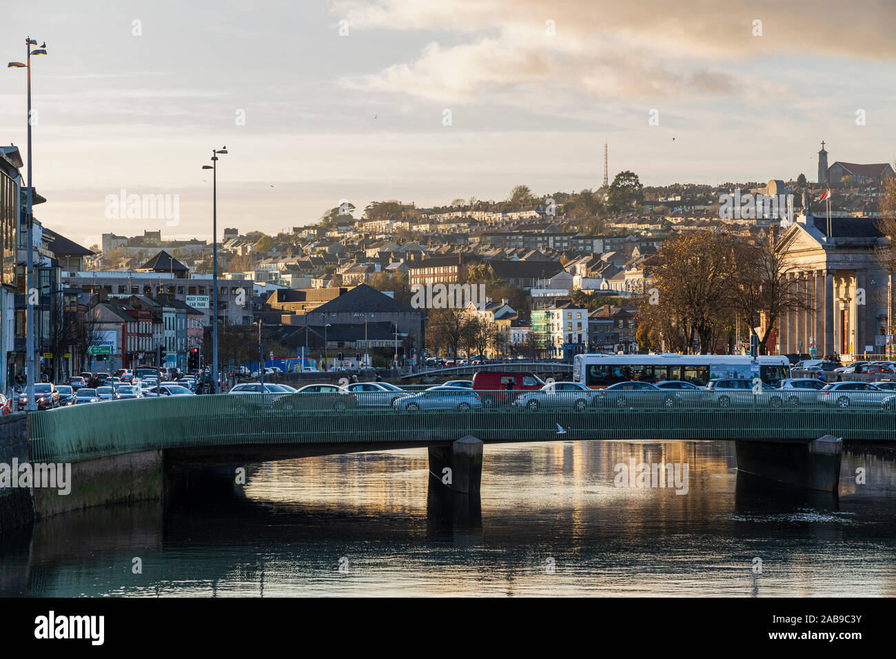Heavy traffic crossing a bridge, looking along the River Lee towards ...