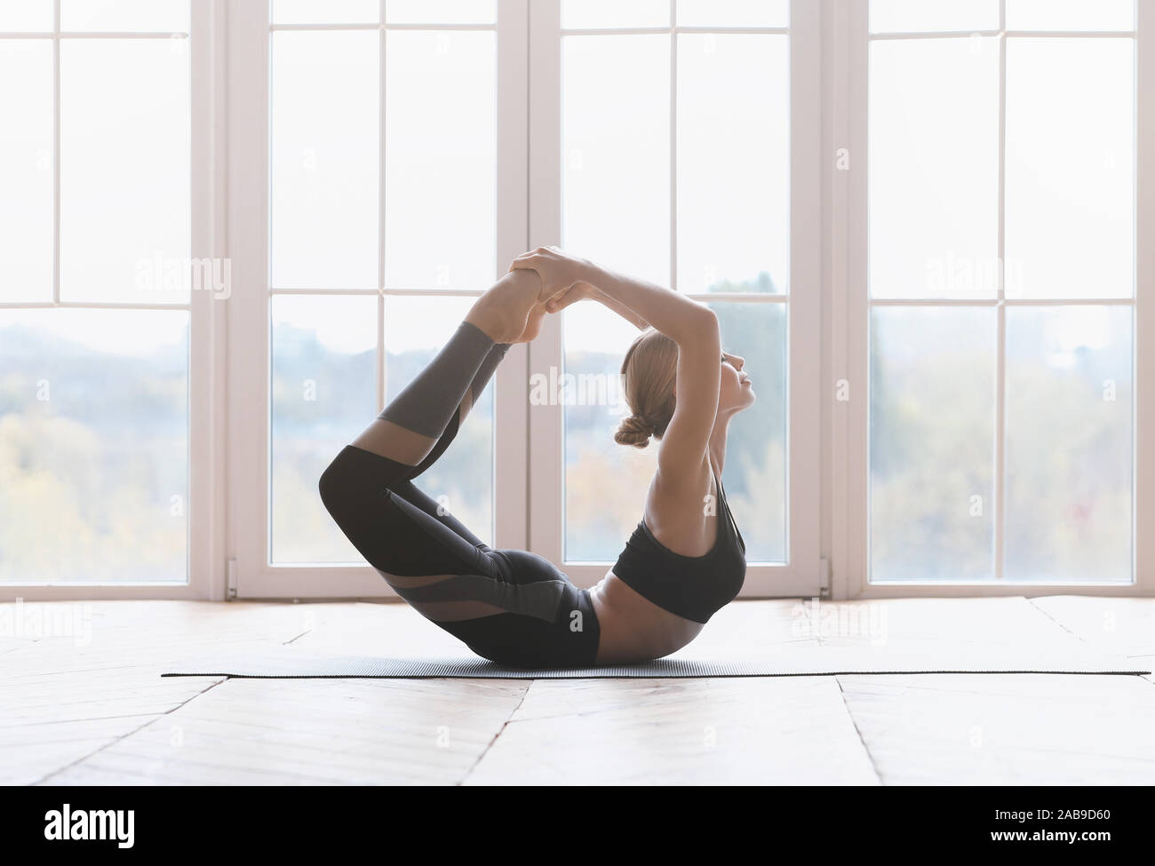 Tiny gymnastic girl exercising at sport studio Stock Photo - Alamy