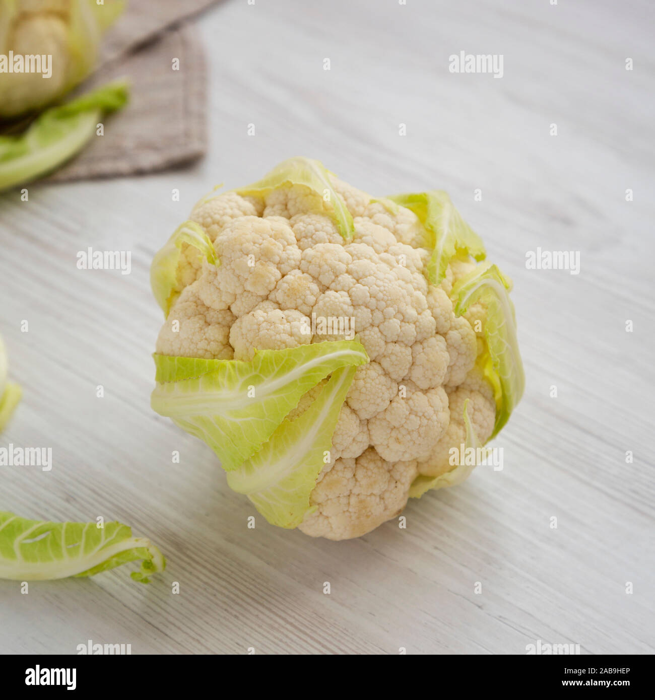 Raw Cauliflower Head on a white wooden background, side view Stock ...