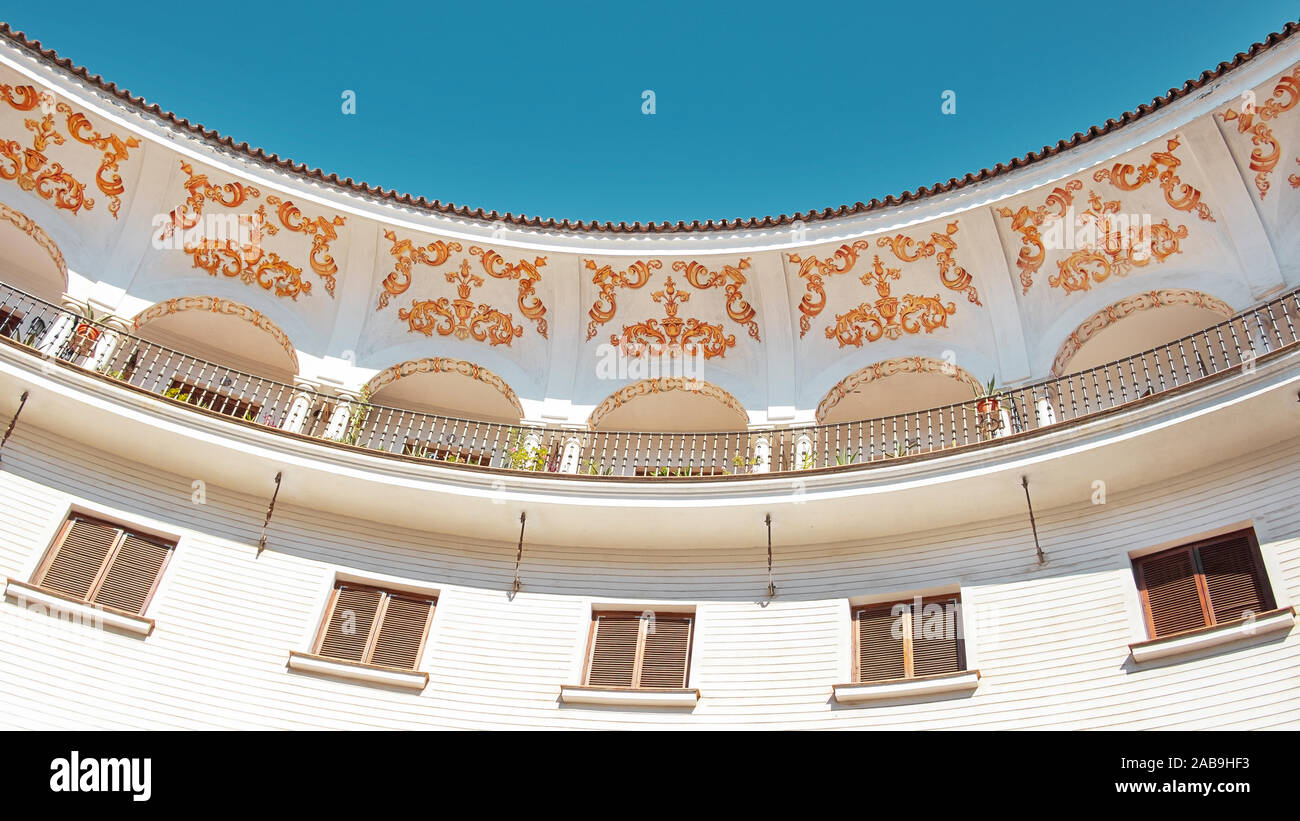 Decorated semi-circular building, the curved side facing the patio ...