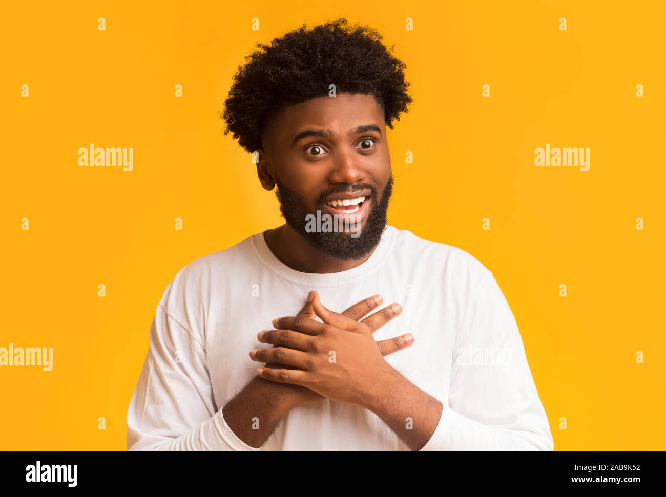 Surprised black guy touching chest with his hands Stock Photo - Alamy
