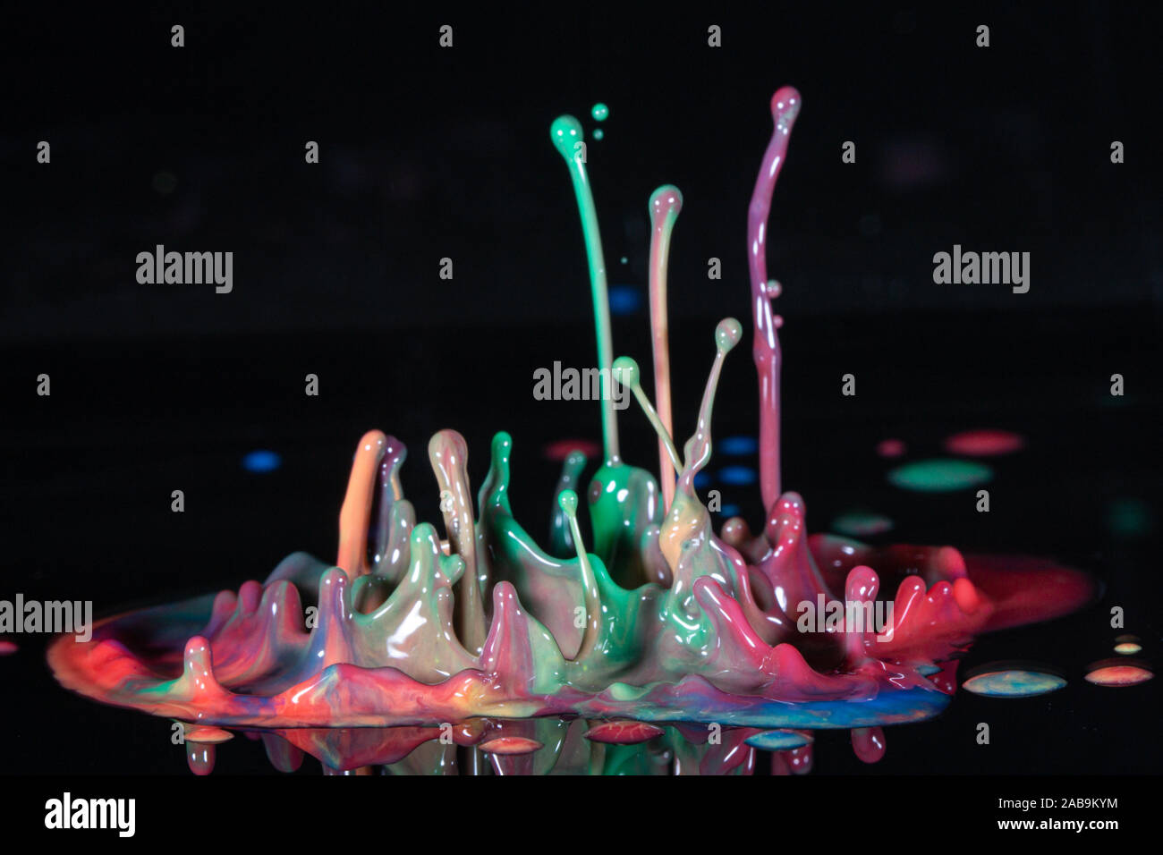 Color ink splash on a black background Stock Photo - Alamy