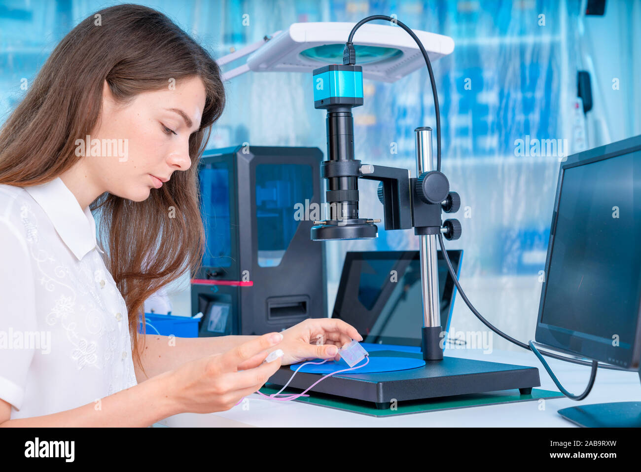 Woman worker in control of Resin LCD / DLP / SLA 3D Printer in ...