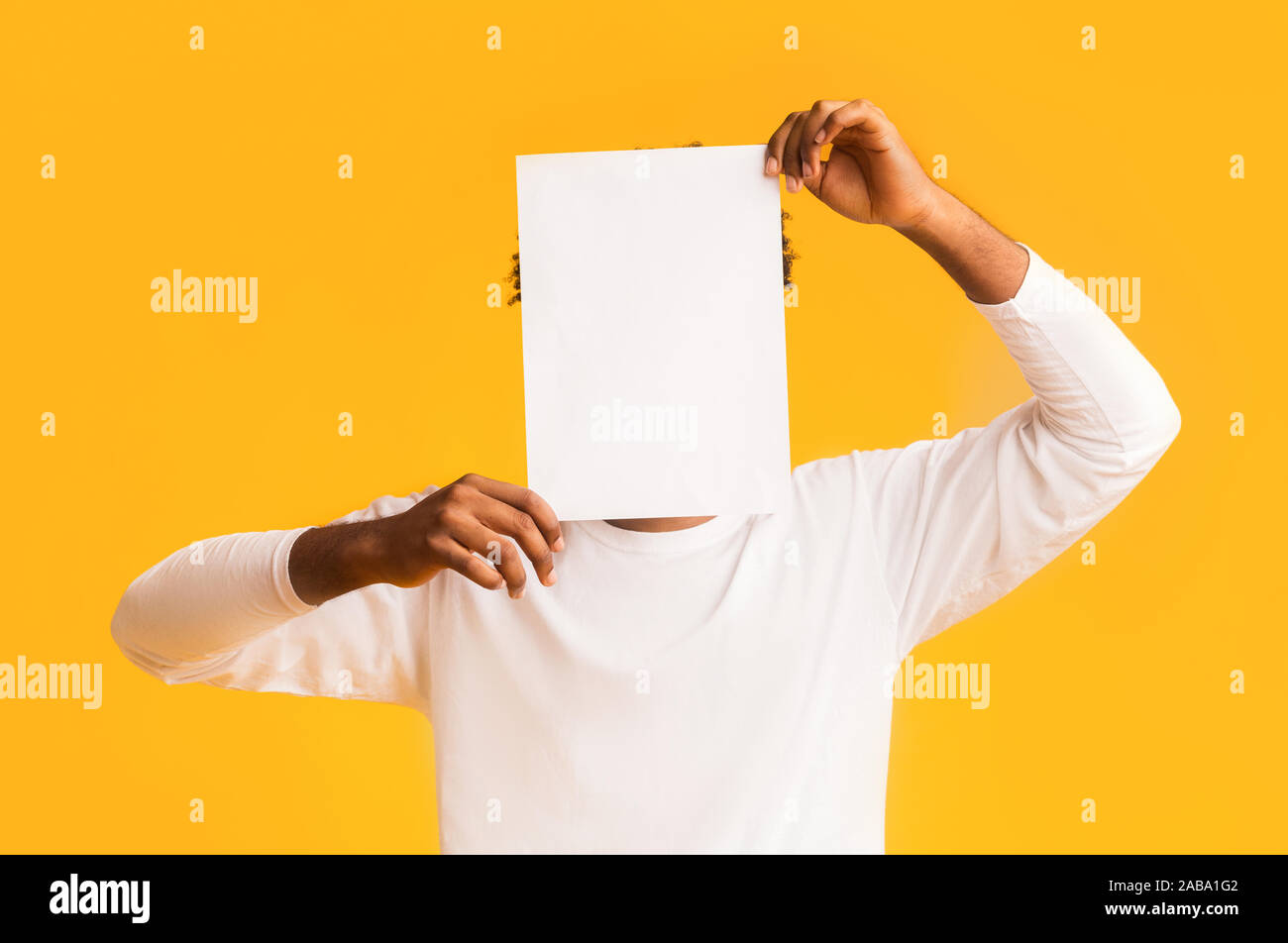 Man covering his face with empty white paper Stock Photo - Alamy