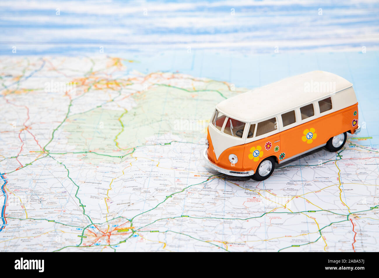 Vacationing camper on a map Stock Photo - Alamy
