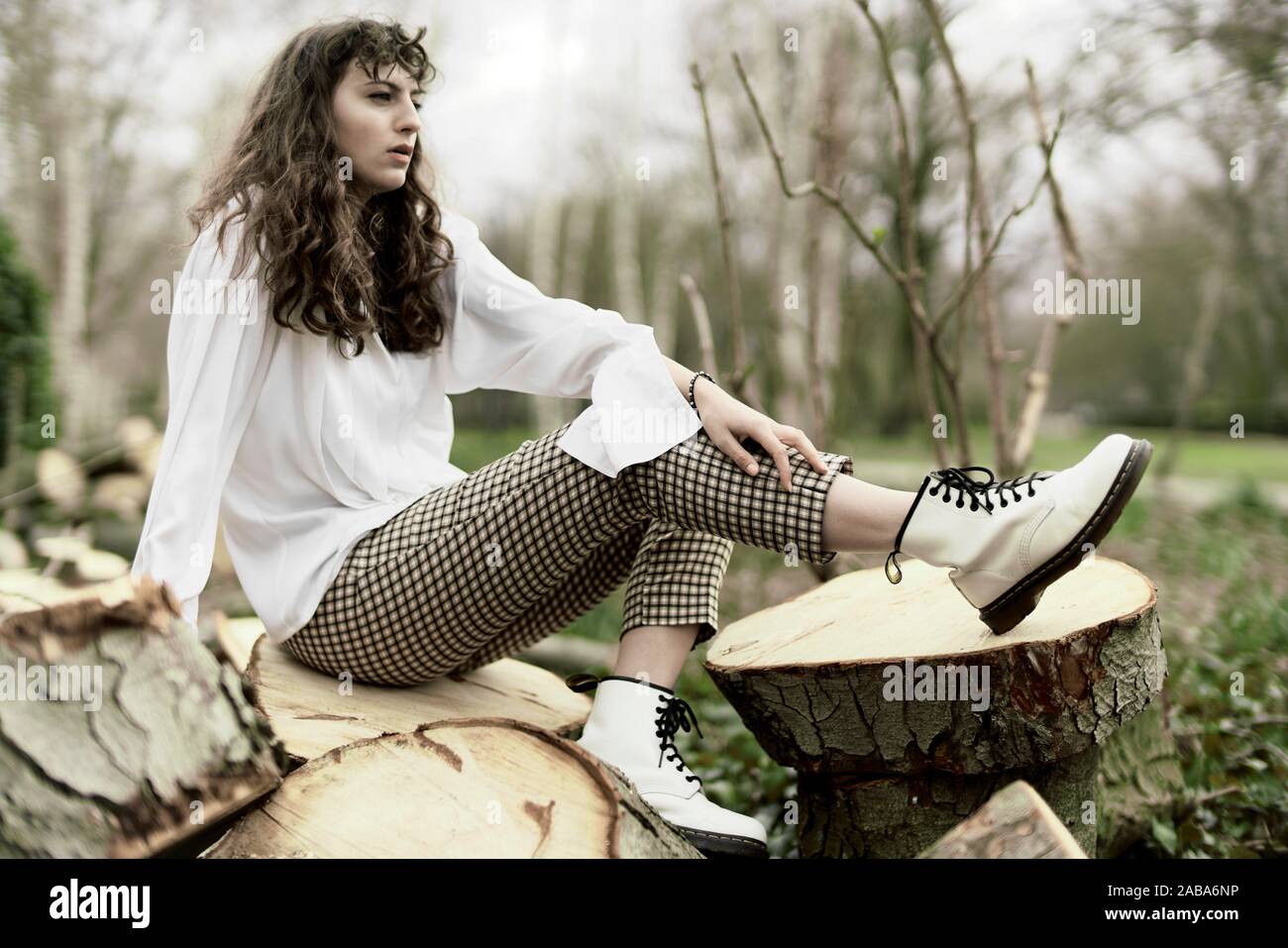 Woman sitting on tree stump hi-res stock photography and images - Alamy