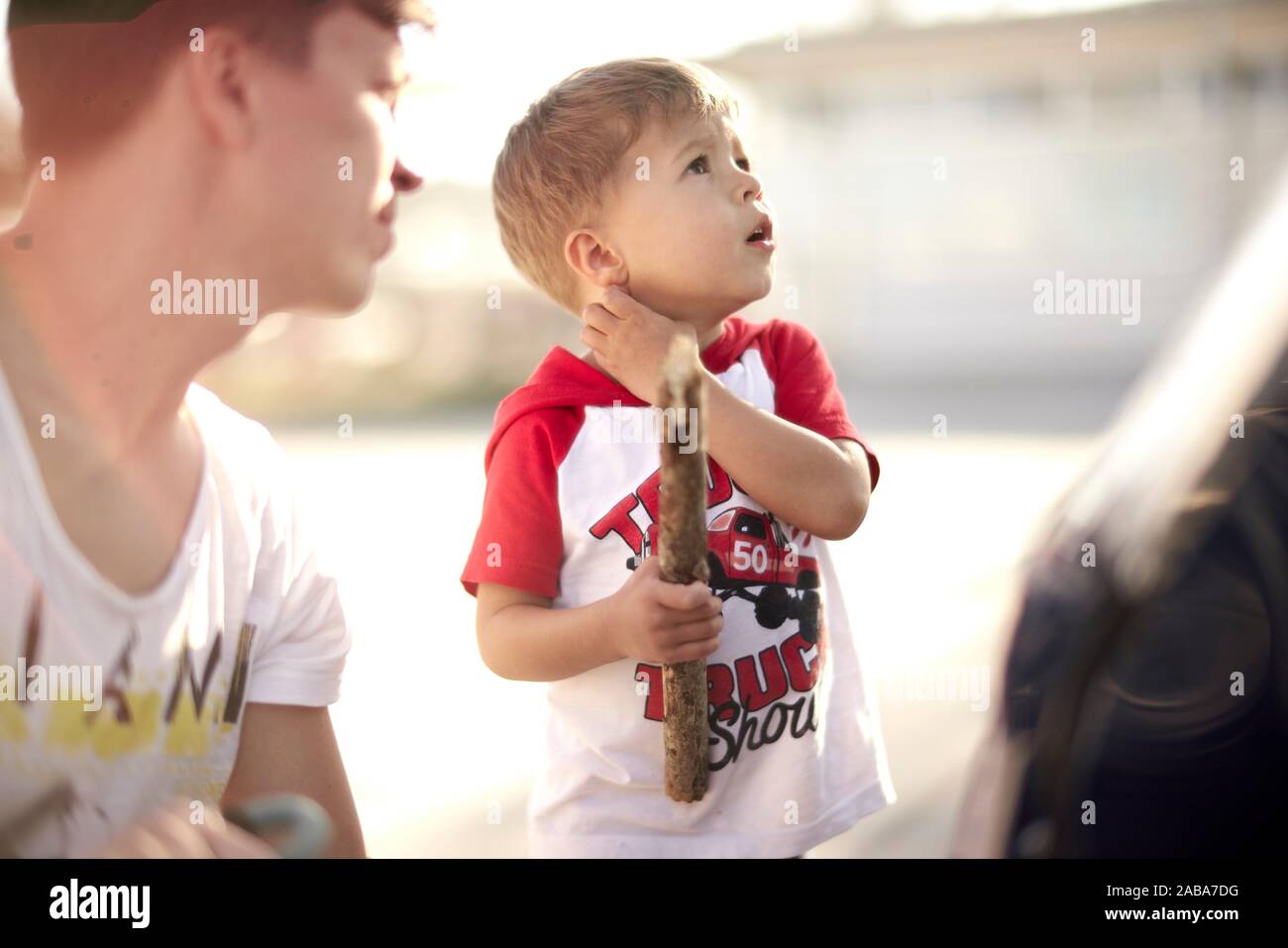 baffled toddler child with questioning expression next to father ...