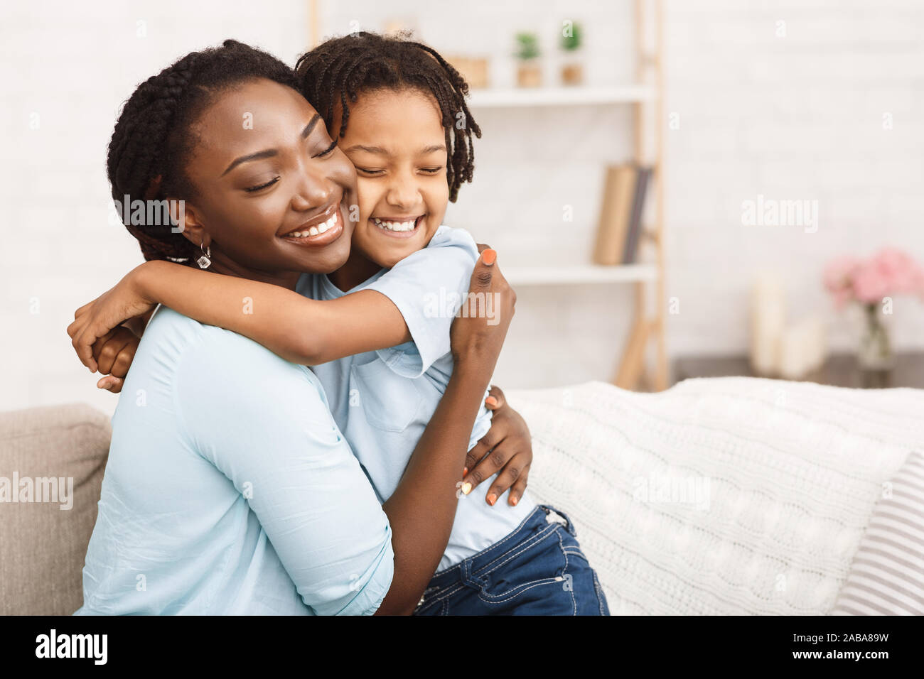 Satisfied black family feeling happy and joyful Stock Photo - Alamy
