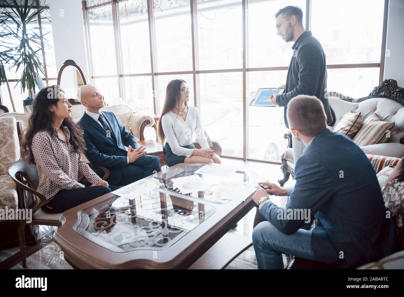 Young team of coworkers making great business discussion in modern ...