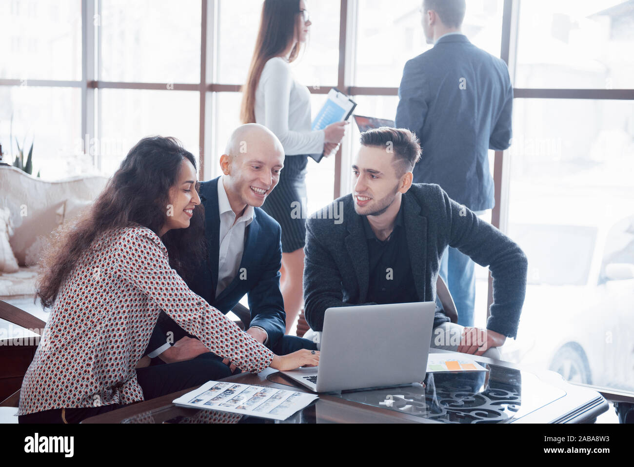 Young team of coworkers making great business discussion in modern ...