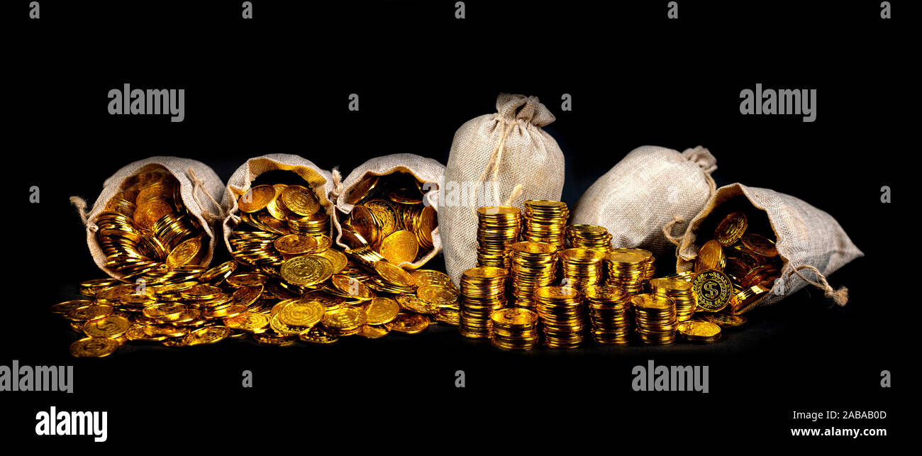 Stacking gold coin in treasure sack at black background Stock Photo - Alamy