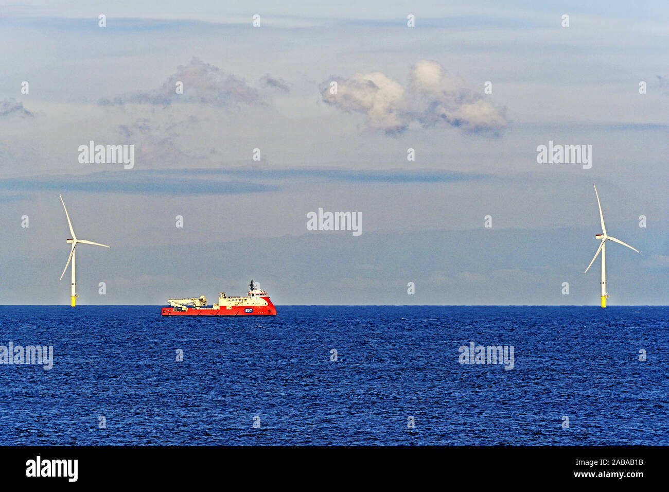 EDT Hercules support vessel by two windfarm turbines North sea Stock ...