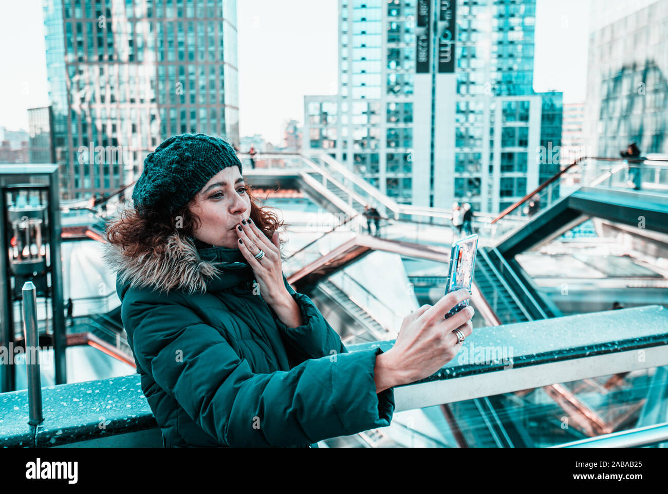 Beautiful curly brunette woman taking selfie self-portrait in The ...