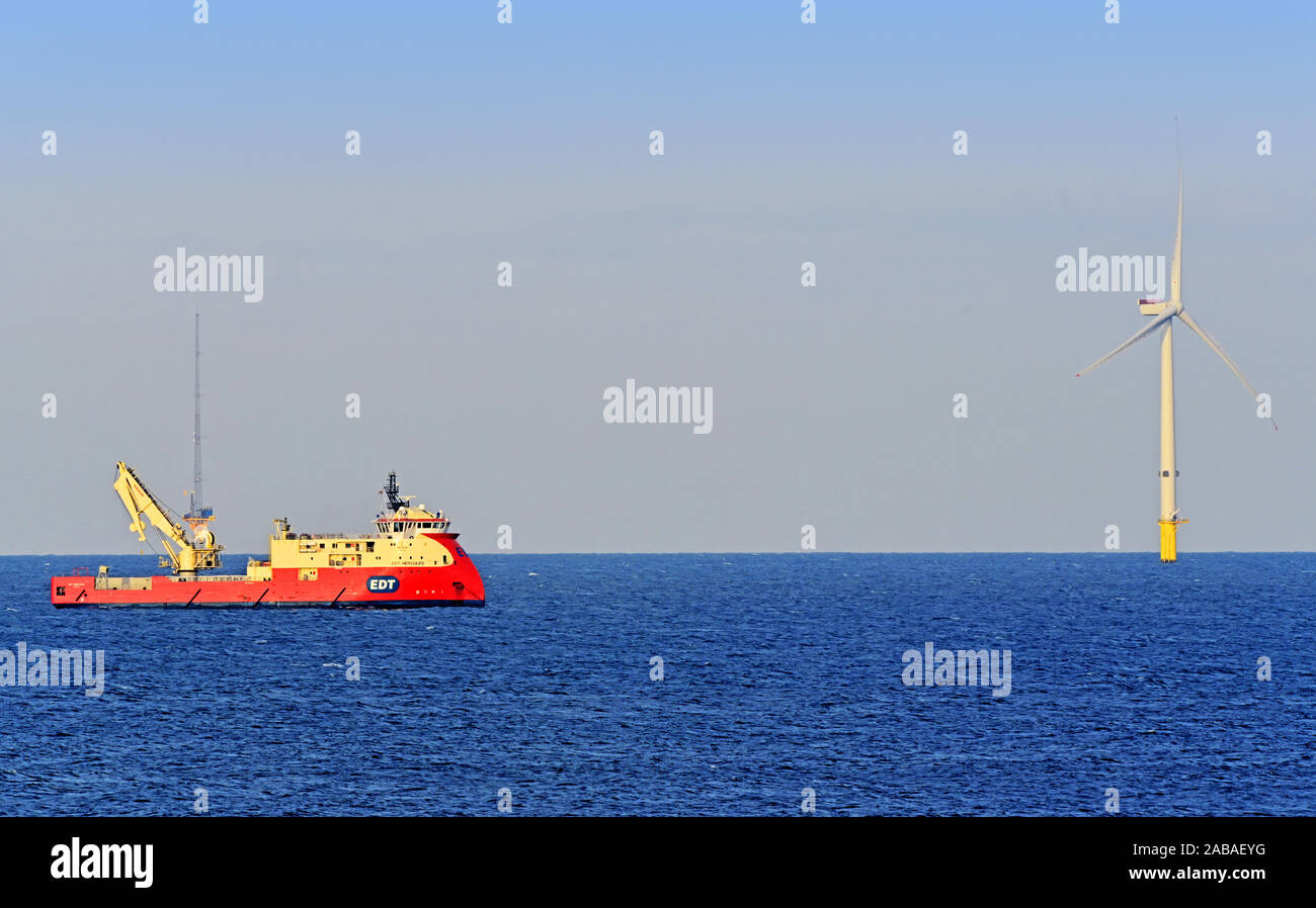 EDT Hercules support vessel by a windfarm turbine and SEAROC platform ...