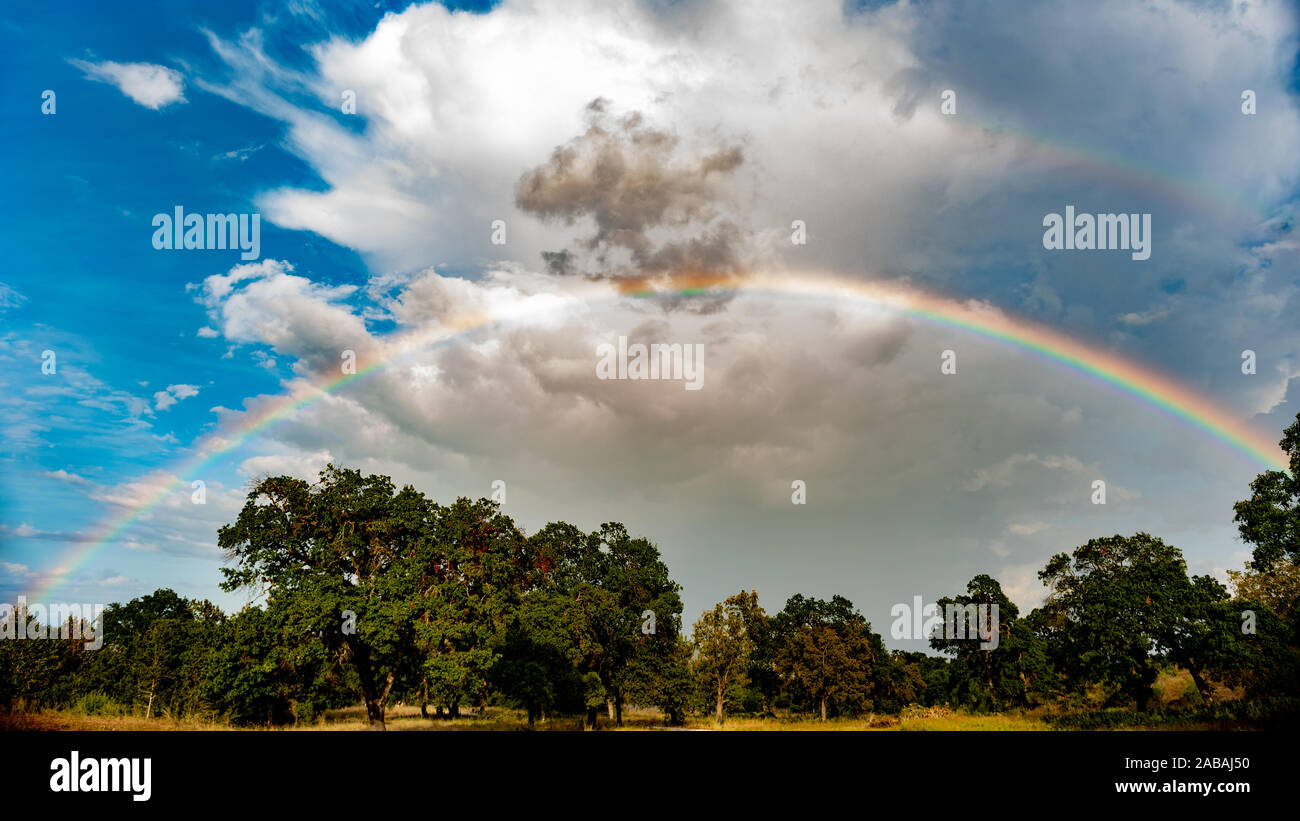 Storm front chasing a rainbow Stock Photo - Alamy