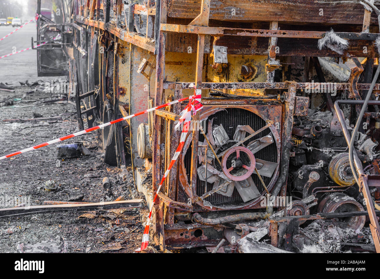 Burnt bus is seen on the street after caught in fire during travel ...