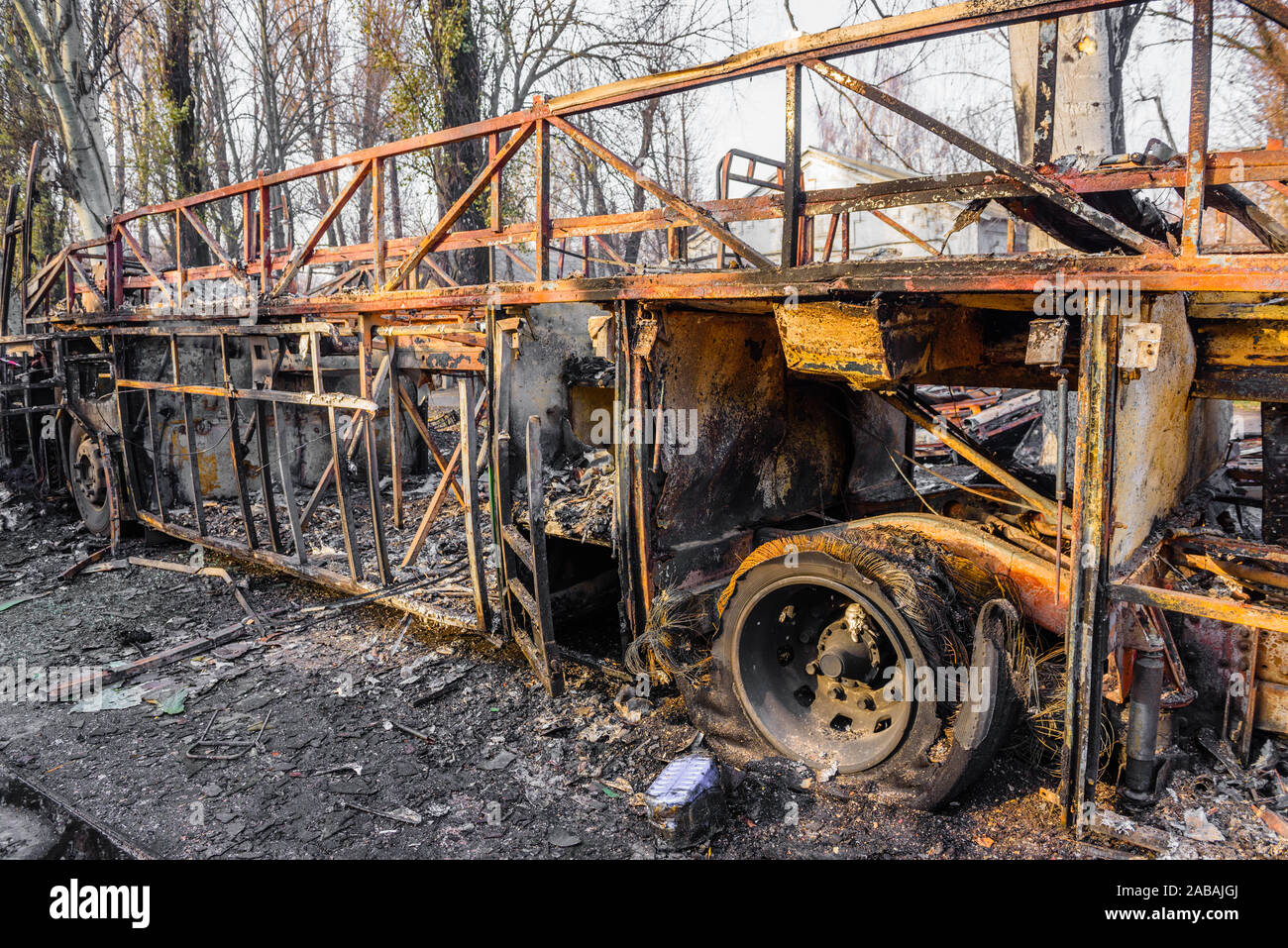 Burnt bus is seen on the street after caught in fire during travel ...