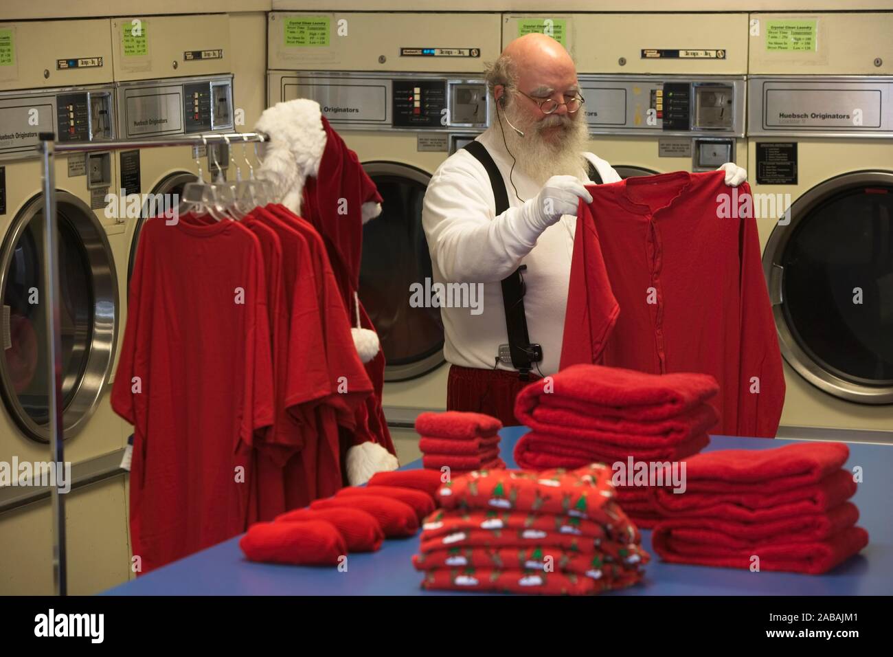 Santa wearing earphones getting ready for Christmas with all his red ...