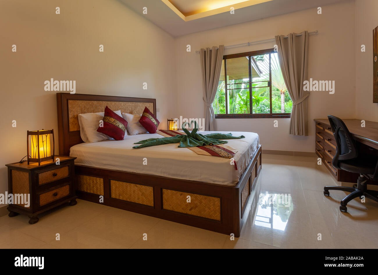 Large bedroom with a large bed in nature style Stock Photo - Alamy