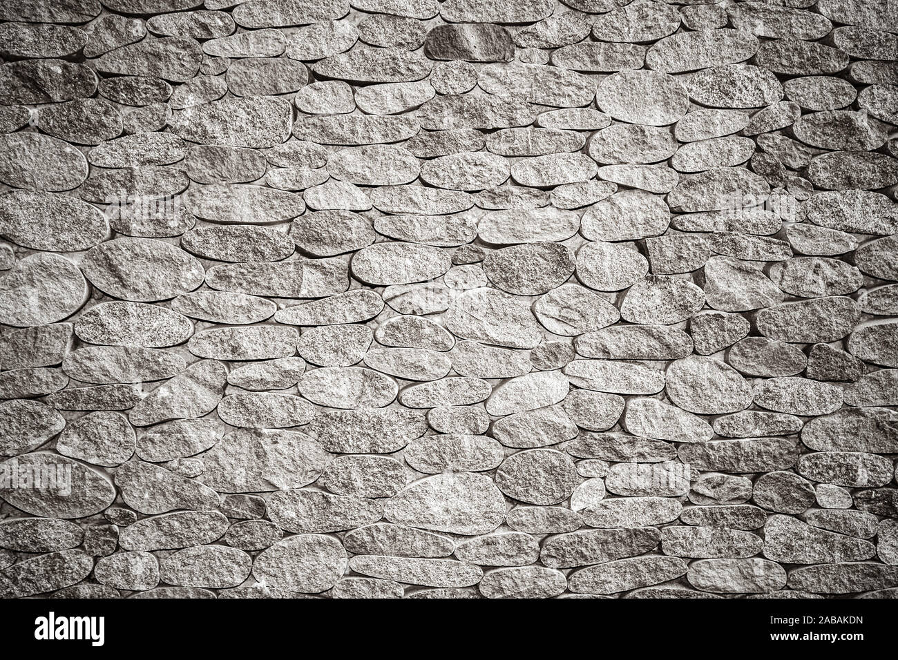 background texture of grey stone wall with vignette, black and white ...
