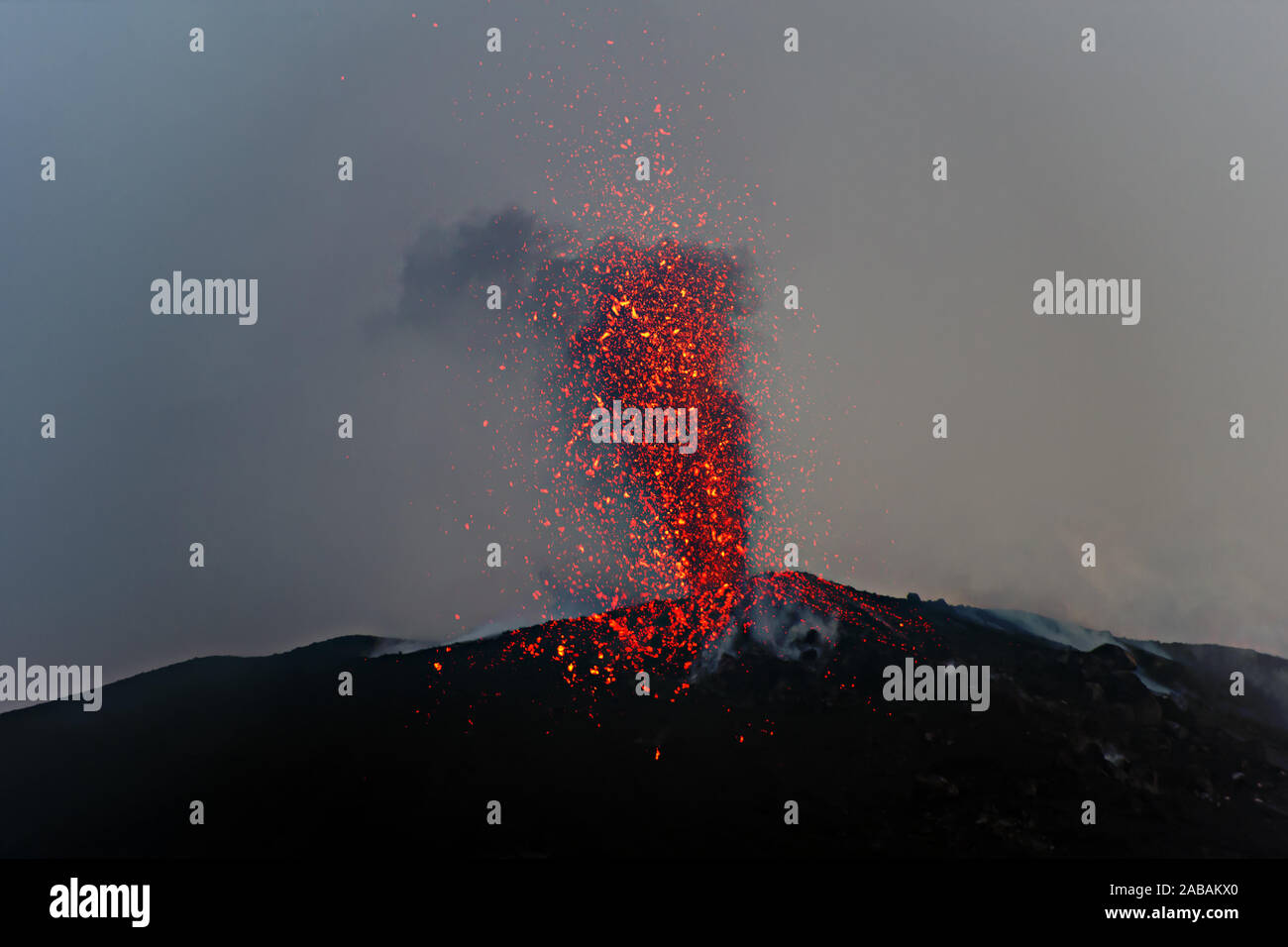 explosive eruption at dusk in one of the three craters of the active ...