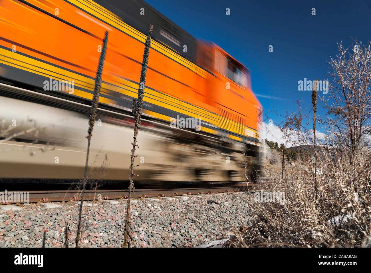 Freight train moving down the tracks with motion blur Stock Photo - Alamy