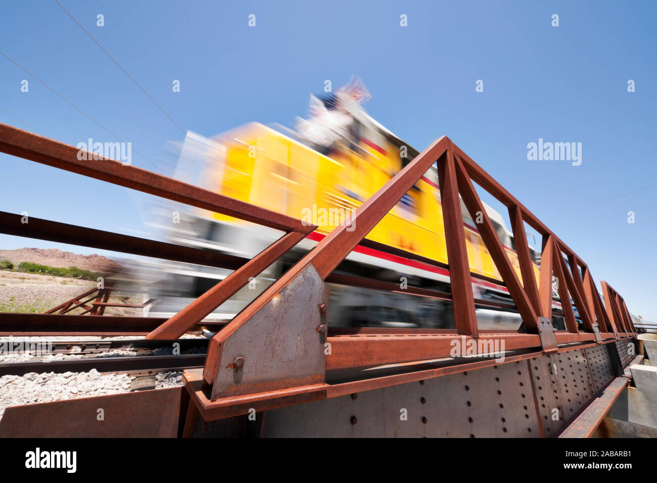 Freight train moving down the tracks with motion blur Stock Photo - Alamy