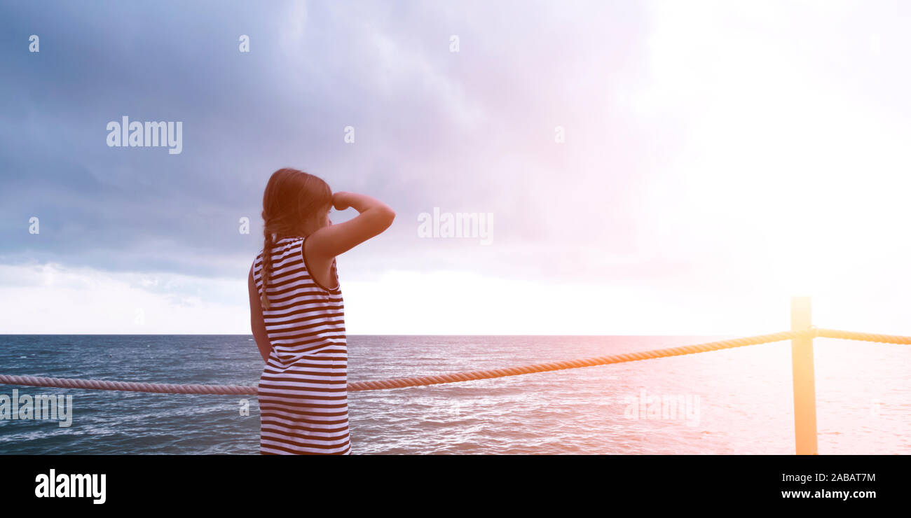 Beautiful little teenager girl standing on ship looking forward with ...