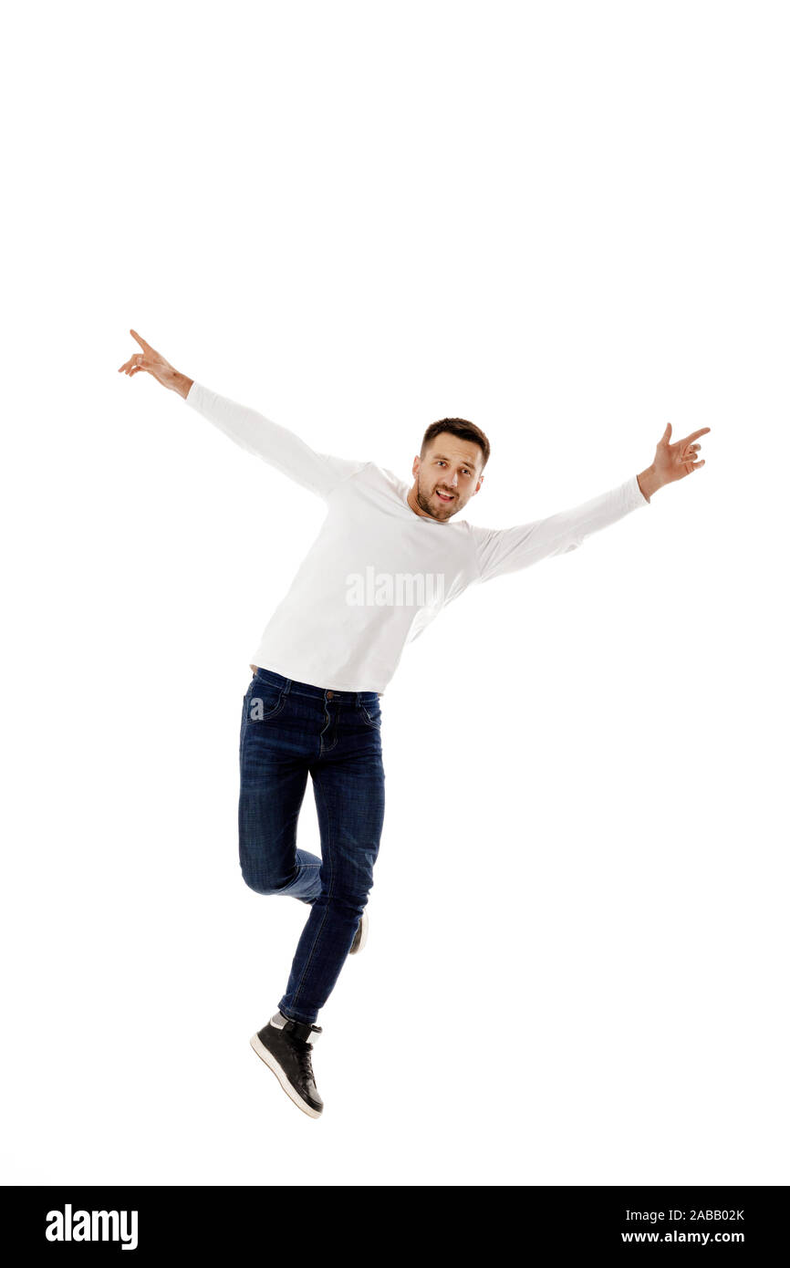 handsome young bearded man jumping. Full length portrait over white ...
