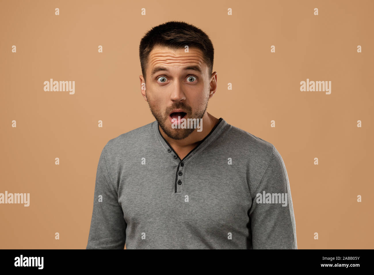 Portrait of young surprised amazed handsome bearded man with shocked ...
