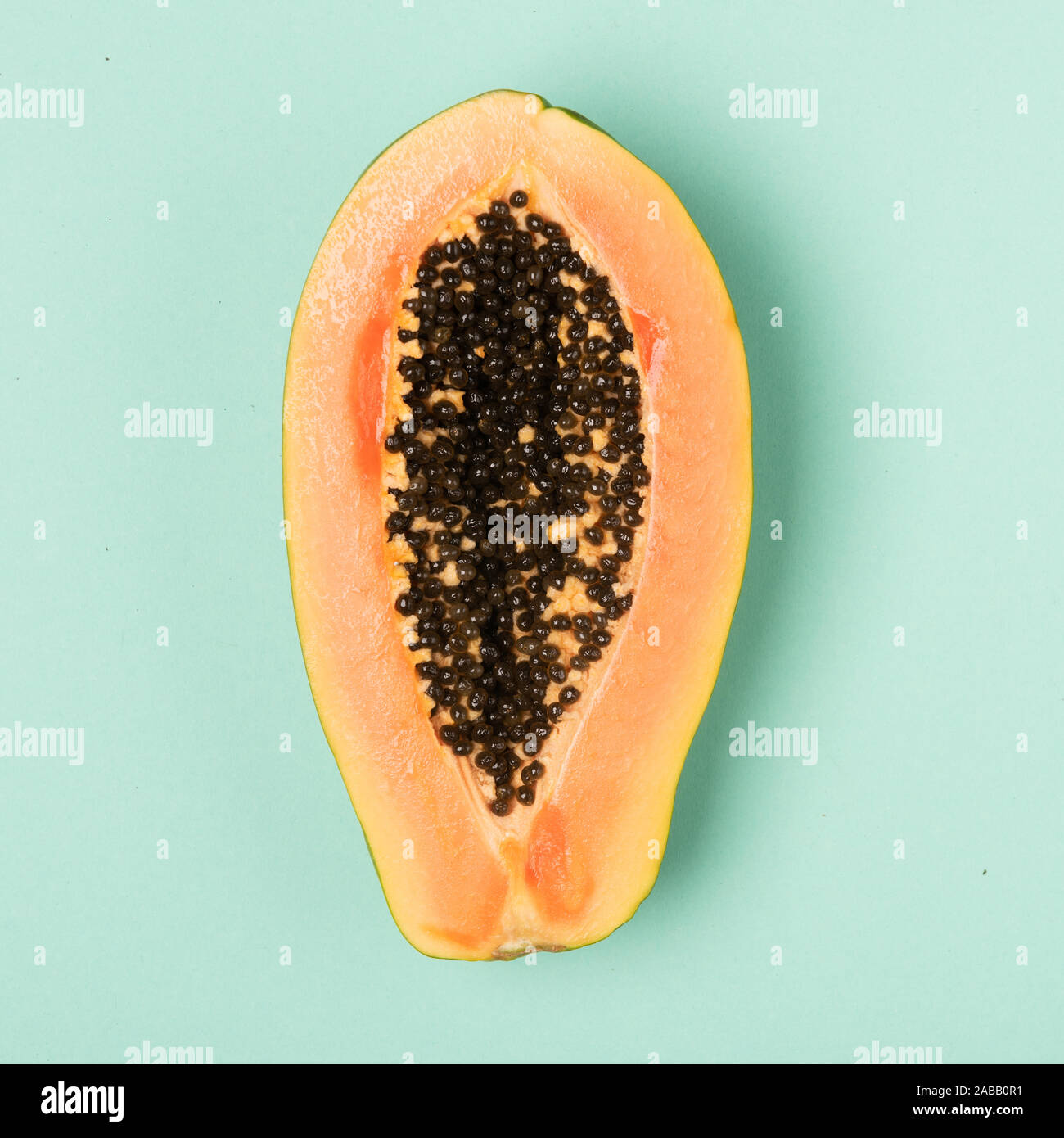 Fresh papaya isolated on mint background Stock Photo - Alamy