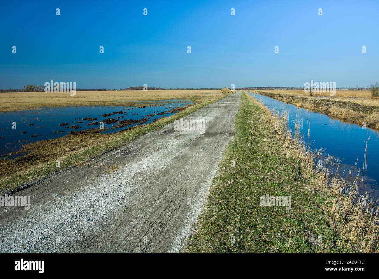 Long dirt road and flooded field after rain, horizon and sky Stock ...