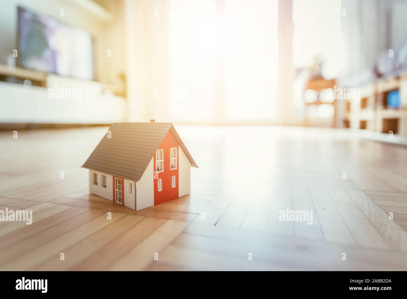 Red house model on the floor, indoors. Concept for new home, property ...