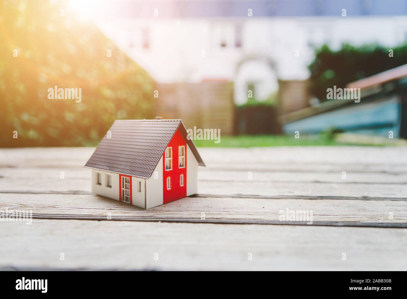 Red house model on the floor, outdoors. Concept for new home, property ...