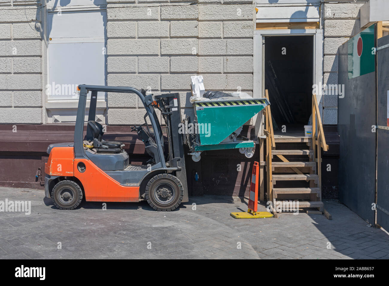 Forklift Truck With Skip Container at Construction Site Stock Photo - Alamy