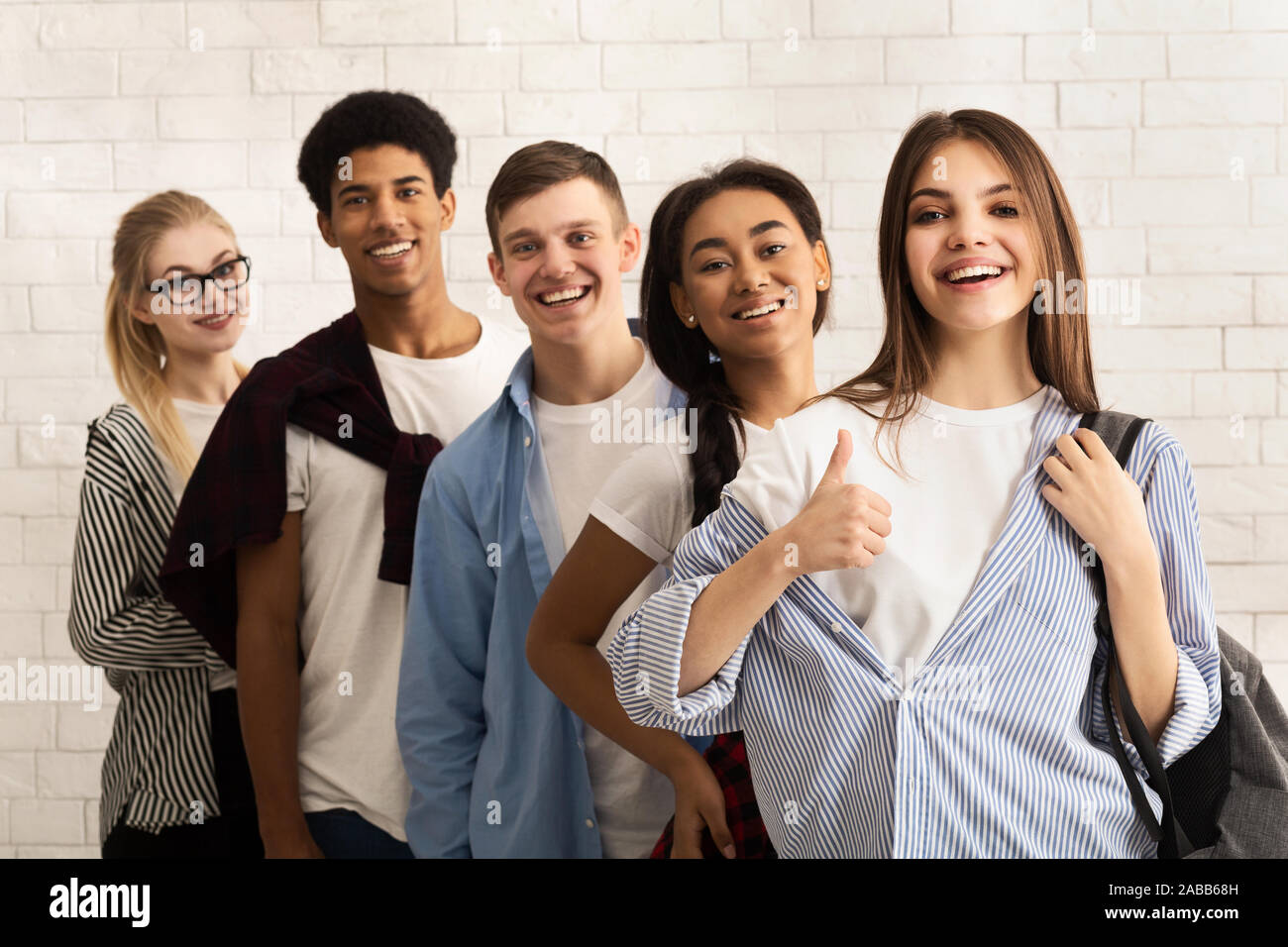 Successful students smiling to camera in row Stock Photo - Alamy