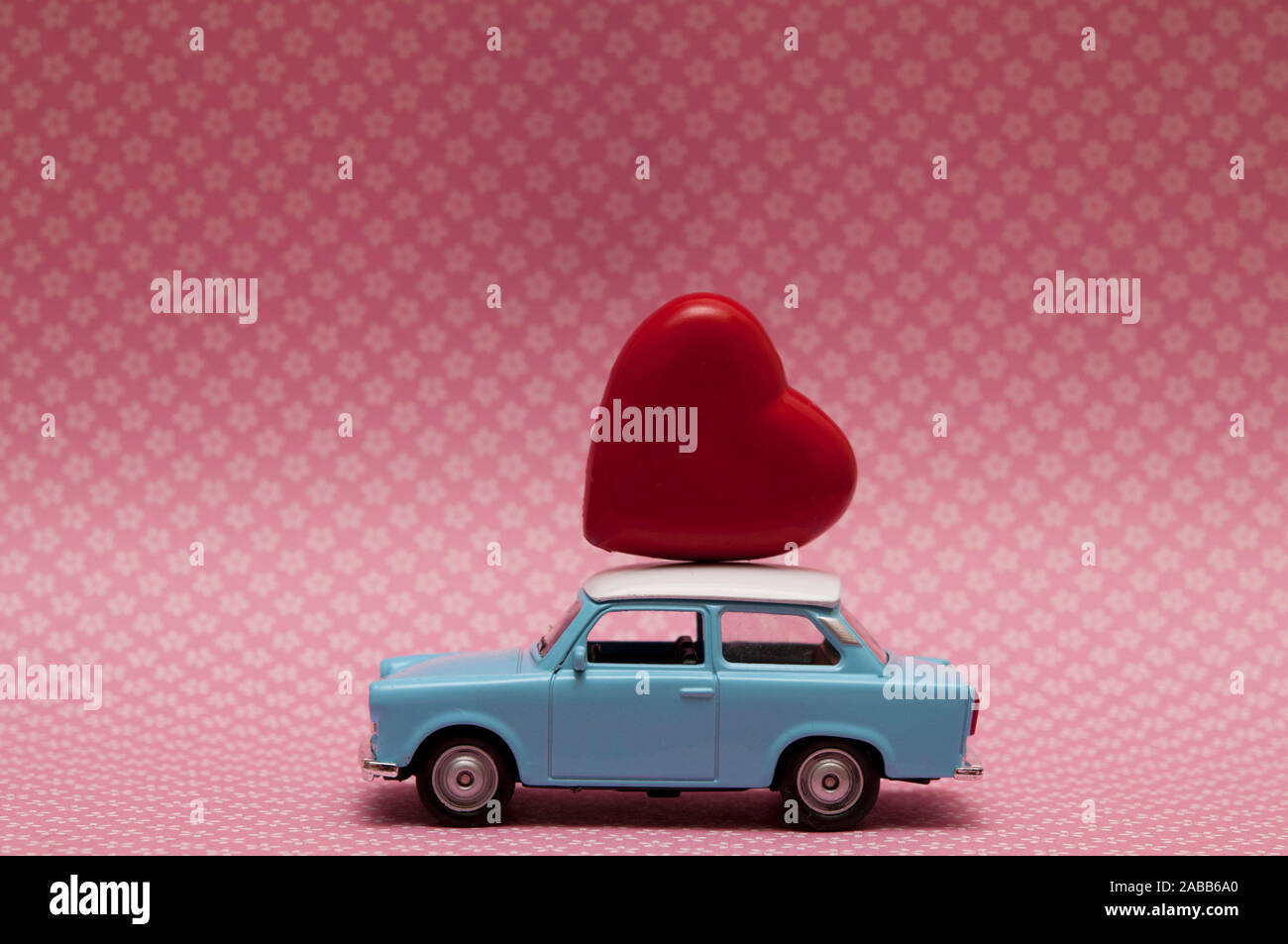 retro blue toy car model with a heart on top of it, valentine concepet ...
