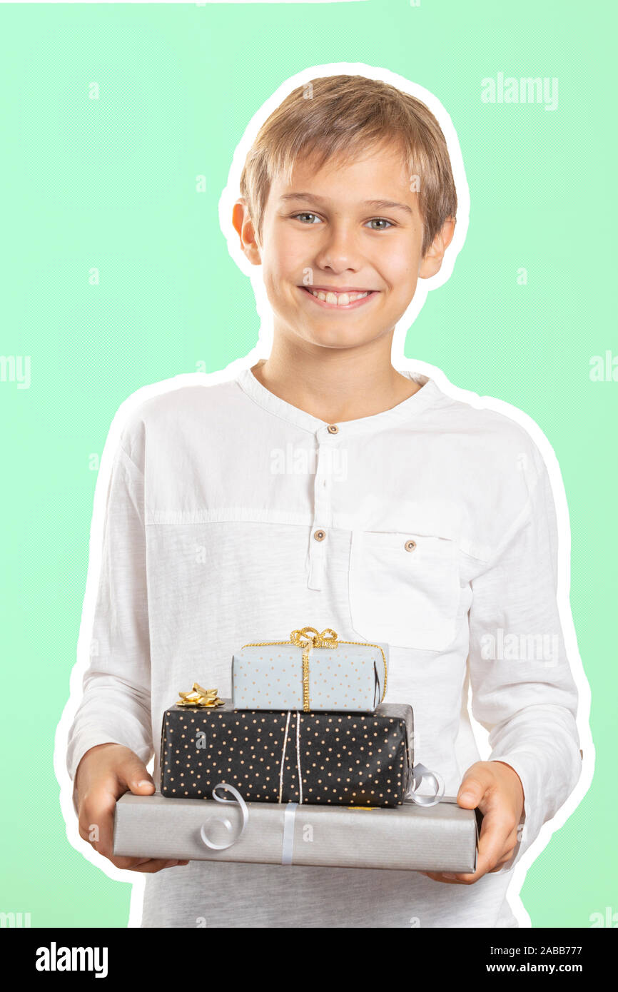 Happy boy holding stack paper wrapped present gift boxes. Magazine ...
